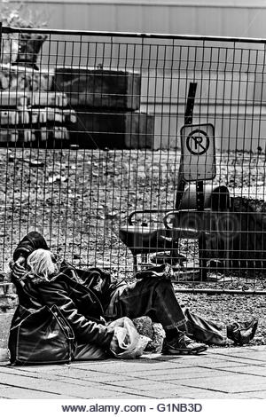 homeless black man in dirty clothing relaxes peacefully sunwarmed by ...