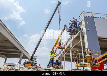 Construction / Workers use a Cherry Picker to work safely at heights ...