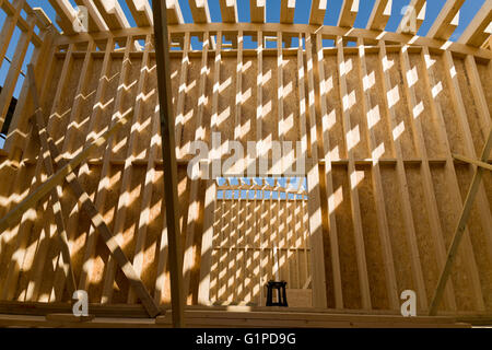 Timber frame building being erected. Wooden structure partially ...