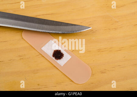 Kitchen knife and band aid, domestic accident concept Stock Photo - Alamy