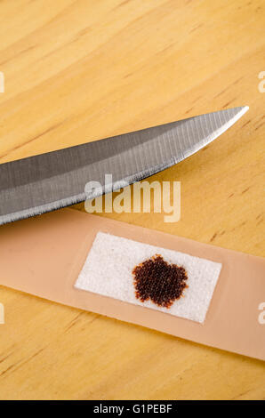 Kitchen knife and band aid, domestic accident concept Stock Photo - Alamy
