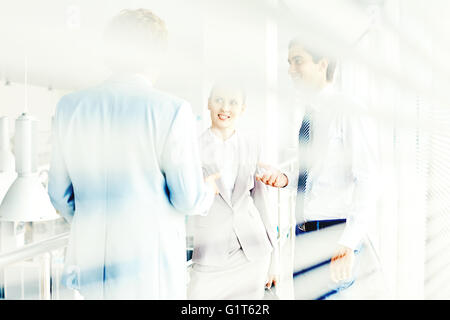 Group of business people working and communicating while sitting at the ...
