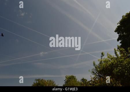 Chemtrails, water vapour trails in the blue sky Stock Photo - Alamy