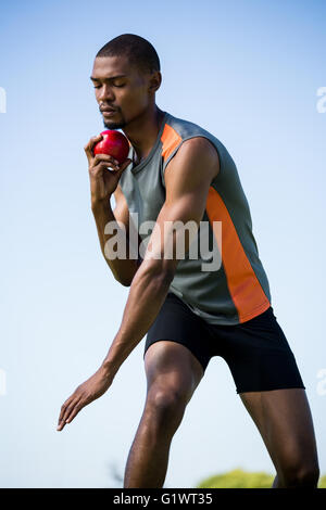 Male athlete holding shot put ball Stock Photo - Alamy