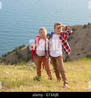 Two brothers walking in mountains near the sea Stock Photo - Alamy