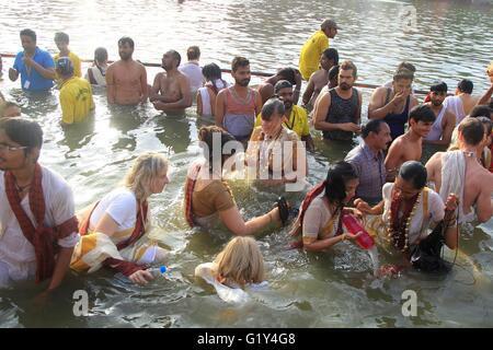 India. 21st May, 2016. Naga Sadhu or holy men takes holy bath in the ...