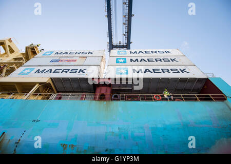 Crew member looking over rail to water below Maersk Container ship ...
