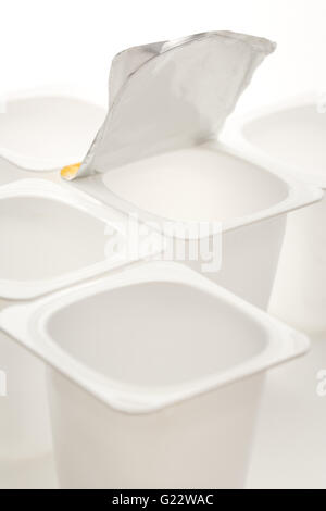 Empty crushed plastic yogurt pots on white Stock Photo - Alamy