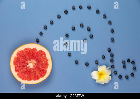 Citrus fruit with blueberry twigs monogram Stock Photo - Alamy