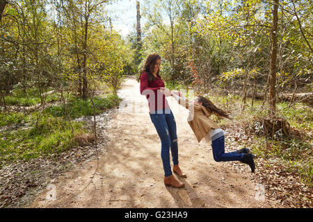 Mother and daughter being spun in circles at park having fun Stock ...
