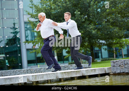 Business people chasing in office Stock Photo - Alamy