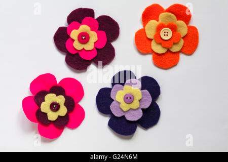 Handmade colourful badges made from felt and buttons isolated on white ...