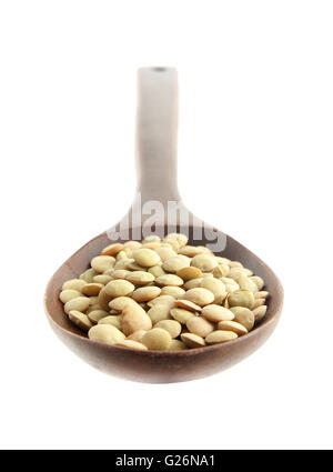 Heap of green lentil with wooden spoon isolated on white background with wooden spoon. Shallow ...