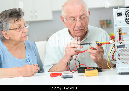 Man testing tower computer with multimeter Stock Photo - Alamy