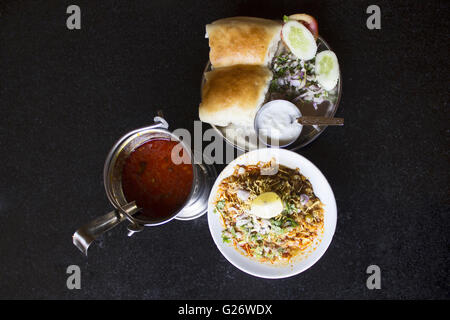 Misal pav. Spicy bean curry and bread topped with potato chiwda mix ...