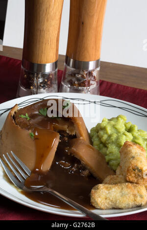 A classic English dish of Steak and Kidney Suet Pudding served with ...
