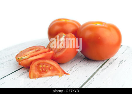 Whole fresh red tomato with a half slice isolated on white background ...