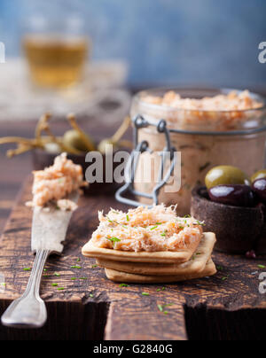 Closeup of crackers with cream cheese and salmon on them on the table ...