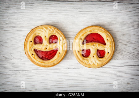 Two round jam biscuits smiling faces isolated on the white background ...