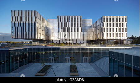 Front elevation with floating volumes and lowered atrium at night ...