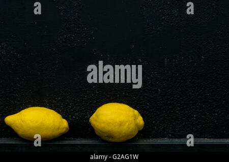 Lemons on old, dark, painted metal surface with copy space Stock Photo ...
