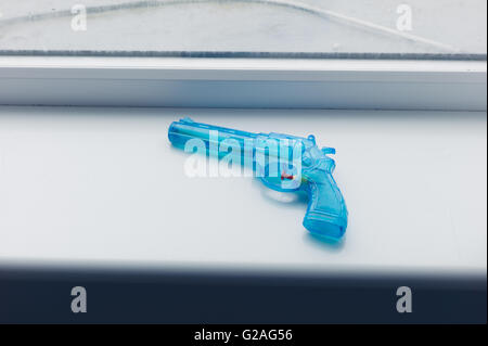 Blue transparent plastic water pistol isolated on a white background ...