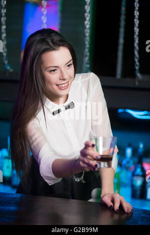 Cheerful brunette woman, female bartender, barmaid, waitress, in black ...