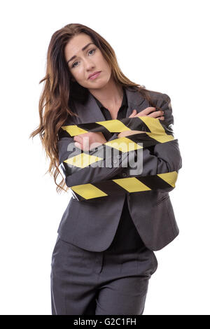 business woman wrapped up in yellow and black tape isolated on white ...