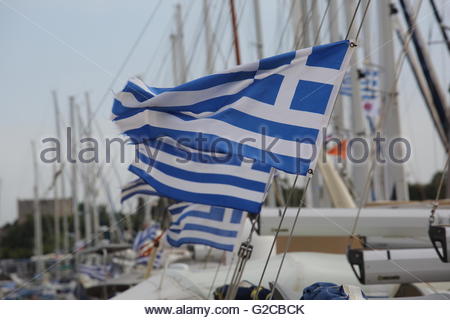 Greek flags blowing in the breeze at a harbour on the island of Rhodes ...