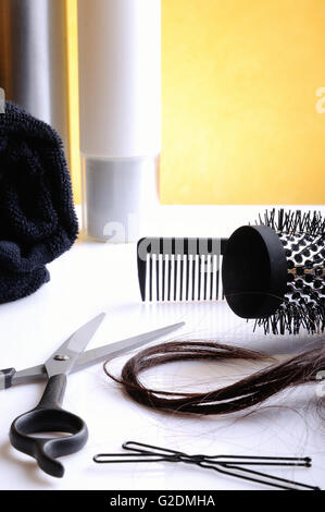 Set hairdressing articles exposed on a glass table and yellow ...