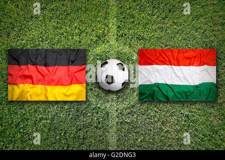 Germany vs. Hungary flags on green soccer field Stock Photo - Alamy