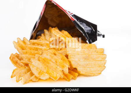 Golden poatato chips pouring out os a bag on white background Stock ...