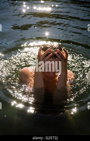 Caucasian woman floating in swimming pool Stock Photo - Alamy