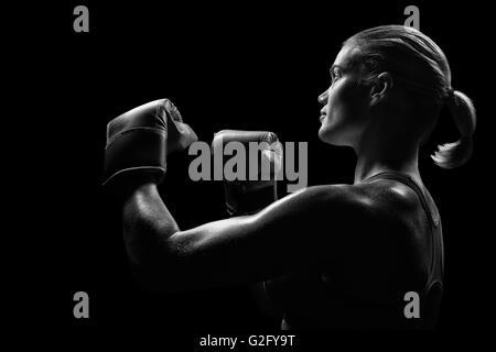 Side view of female boxer with fighting stance Stock Photo - Alamy