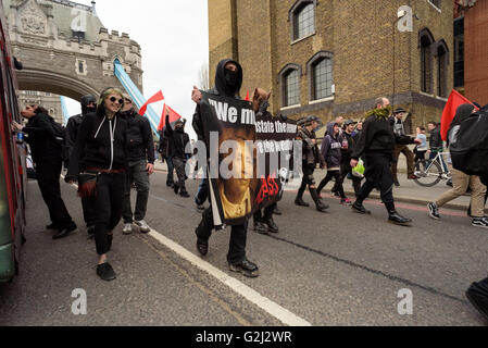 May Day Anarchist group with hidden faces, slogans and red flags ...