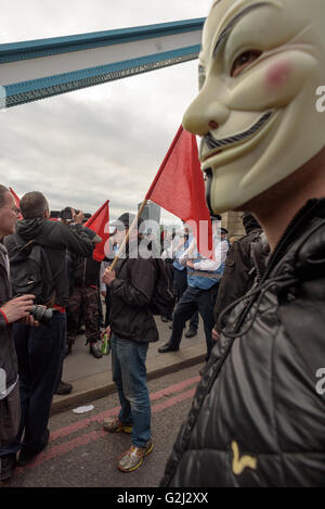May Day Anarchist group with hidden faces, slogans and red flags ...