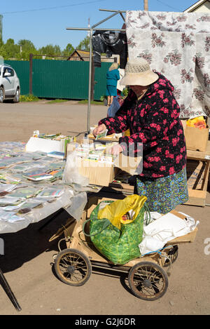 A Russian seed seller sells packets of vegetable seeds to members of ...