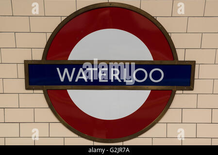 Waterloo Underground Station sign and logo on the wall next to platform ...