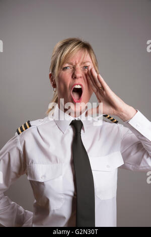 OFFICER SHOUTS AN ORDER Portrait of a female uniformed officer shouting ...