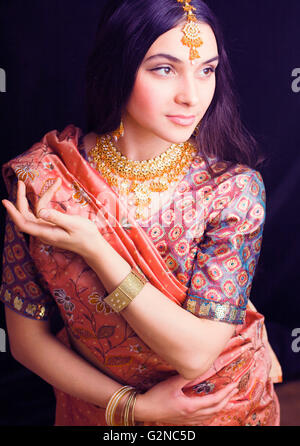 beauty sweet real indian girl in sari smiling on black background ...