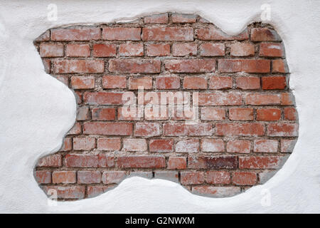 Red brick wall texture partially exposed over plaster background for ...