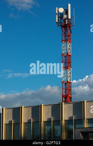 Red and white communication tower on blue sky Stock Photo - Alamy