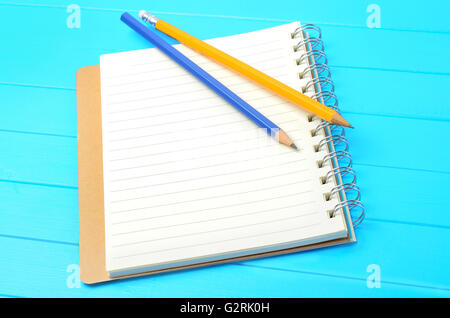 Blue notepad and wooden pencils on a blue background, top view Stock ...
