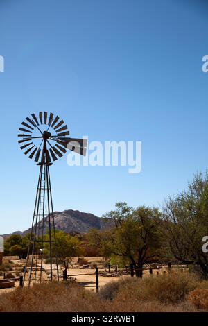 Windmill in the desert landscape of Namibia Stock Photo - Alamy