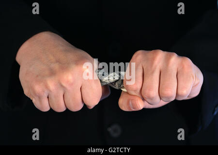 Businessman trying to save money Stock Photo - Alamy