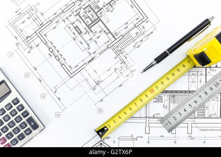 Construction drawings, tape line, calculator and helmet. Desk Engineer ...