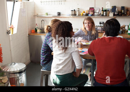 Group Of Designers Meeting Around Table In Modern Office Stock Photo ...