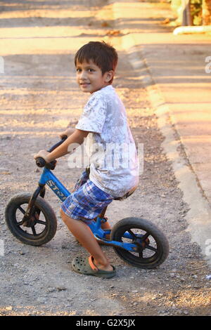 Boy riding blue bike Stock Photo - Alamy