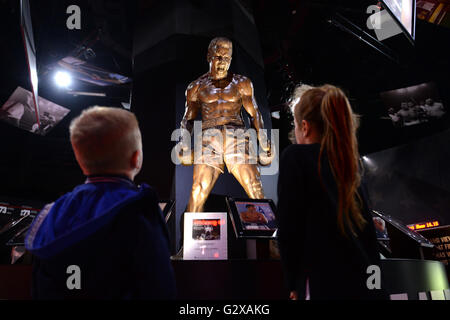 Visitors look at a statue of Muhammad Ali on display at the Muhammad ...