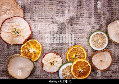 burlap background dried fruits apple orange Stock Photo - Alamy